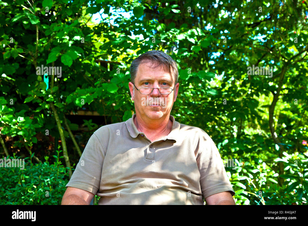 man sitting in his garden Stock Photo - Alamy
