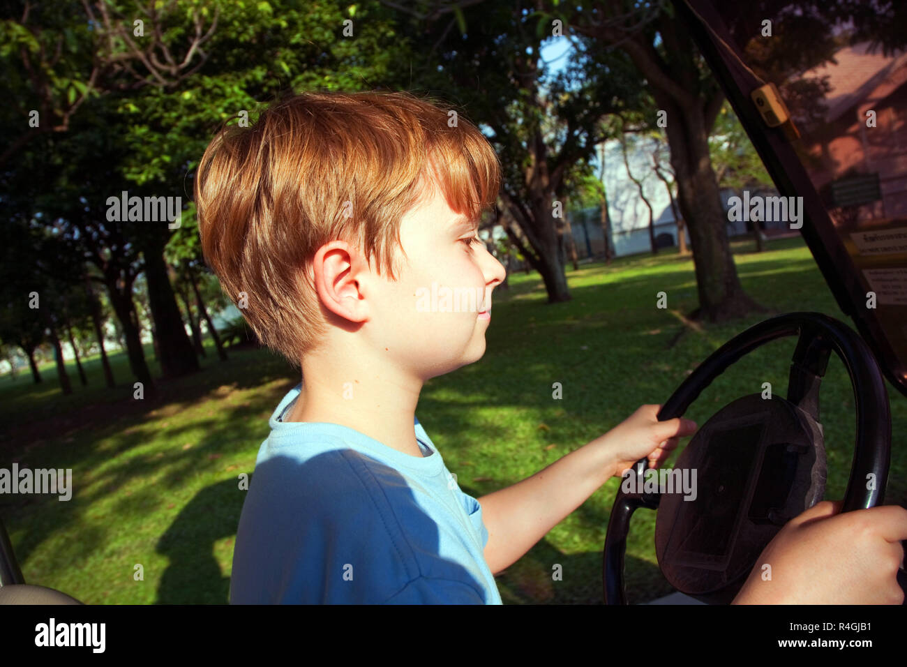 boy likes to drive an electric car in an old palace of a former Thai ...