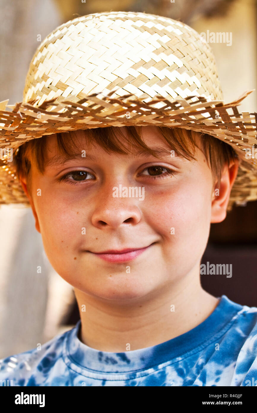 young boy with straw hat is happy and smiles Stock Photo - Alamy