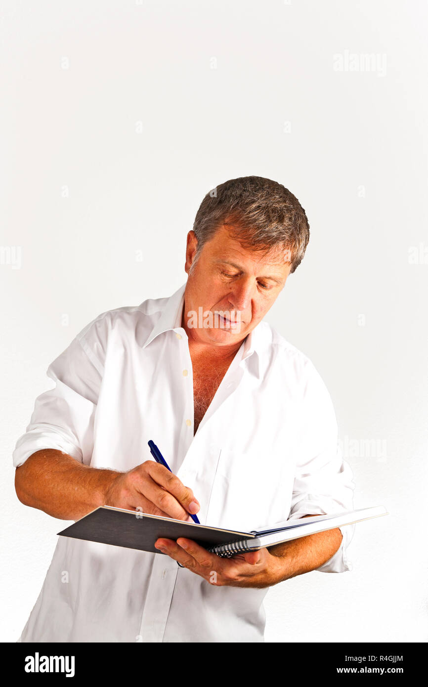 man writing in a book Stock Photo - Alamy