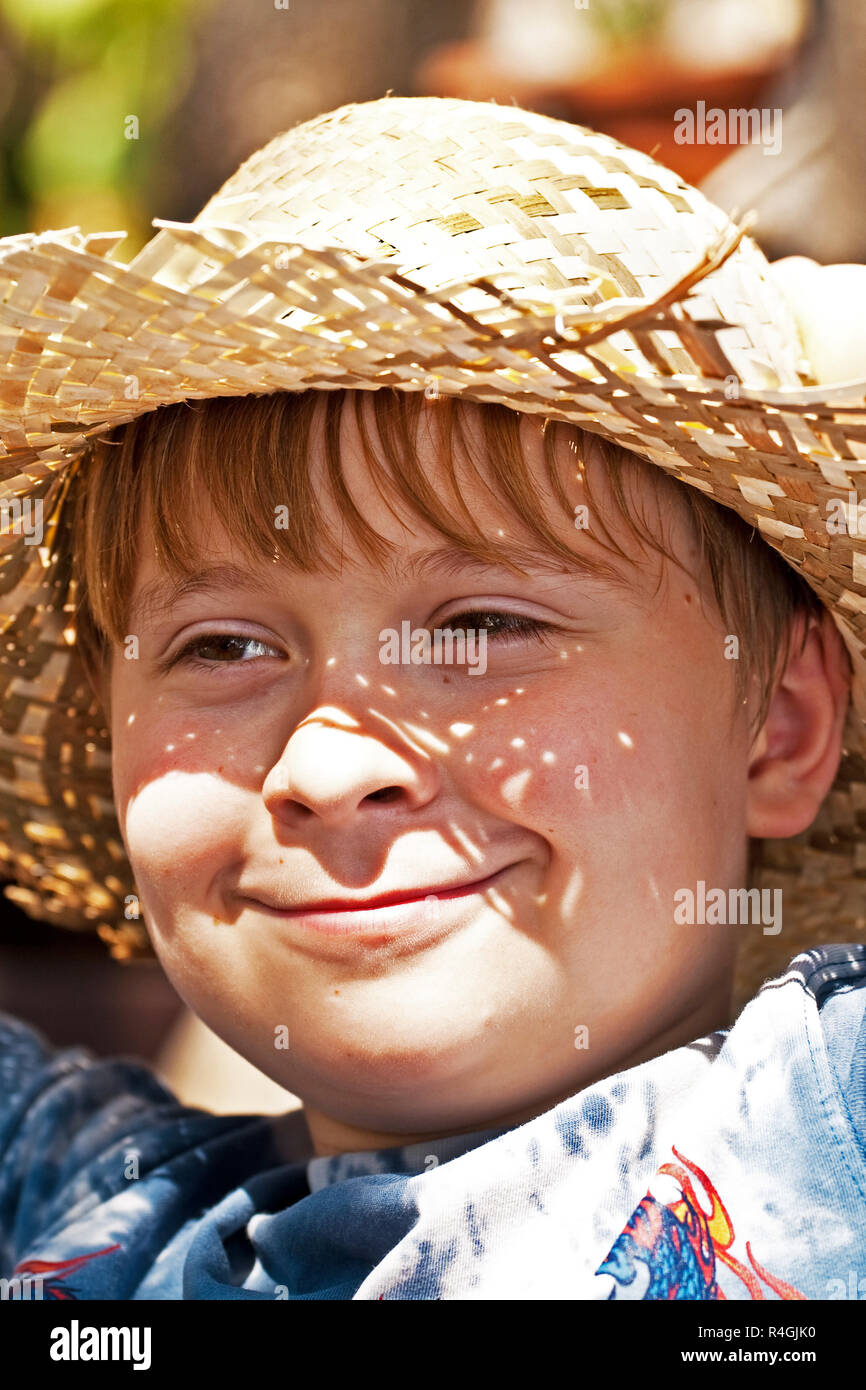 young boy with straw hat is happy and smiles Stock Photo - Alamy