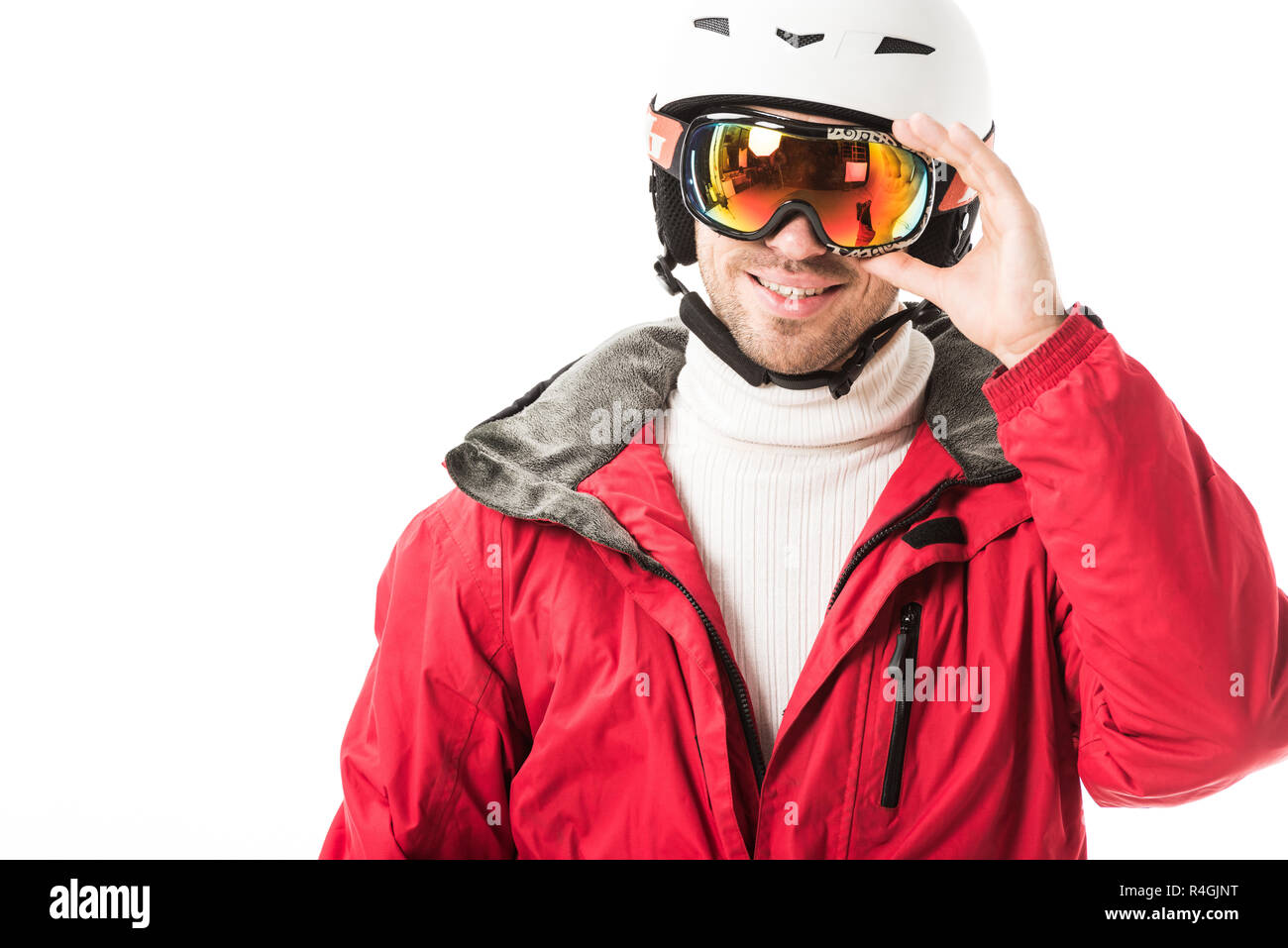 adult man in red ski jacket and helmet putting on goggles and smiling ...