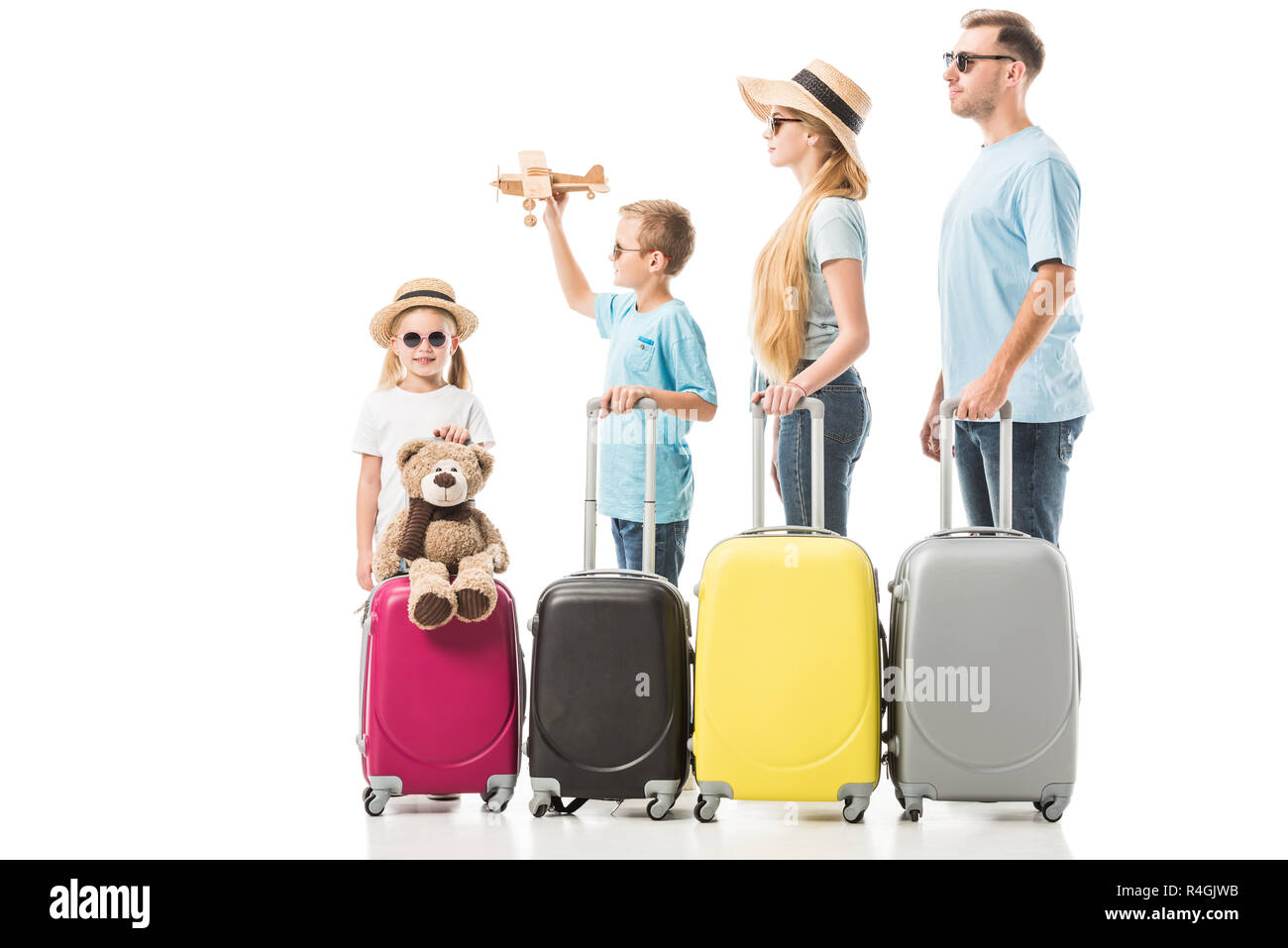 Happy family standing with baggage isolated on white Stock Photo - Alamy