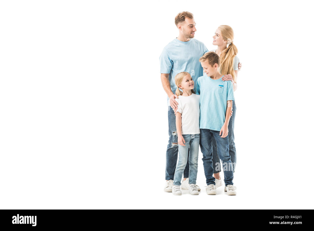 Happy family standing in jeans and smiling isolated on white Stock ...