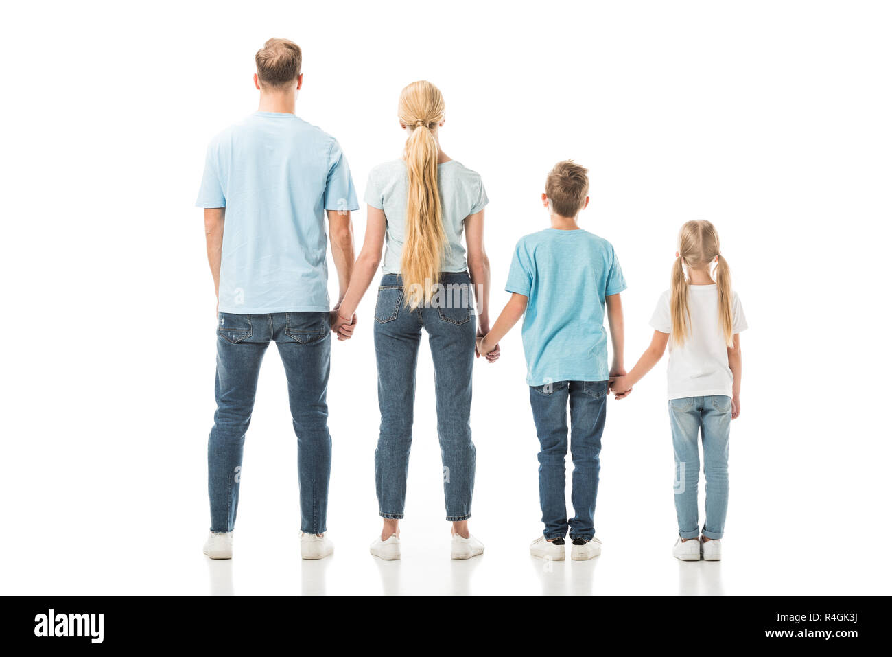 Back view of family standing and holding hands isolated on white Stock ...
