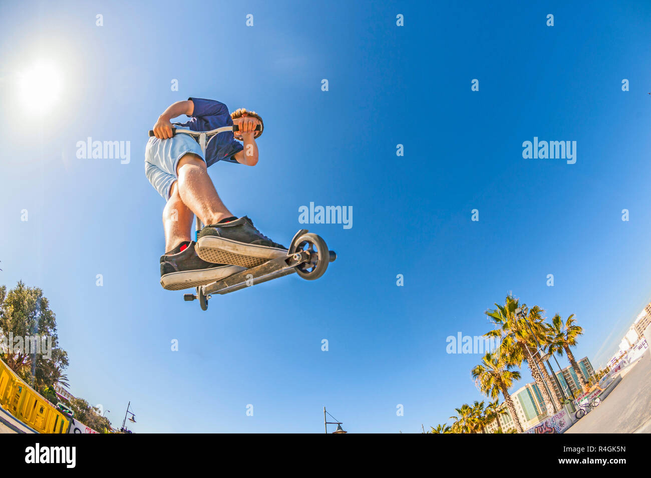 boy jumps with his scooter over a ramp Stock Photo - Alamy