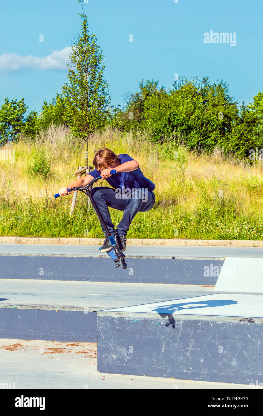 boy has fun riding his push scooter Stock Photo - Alamy