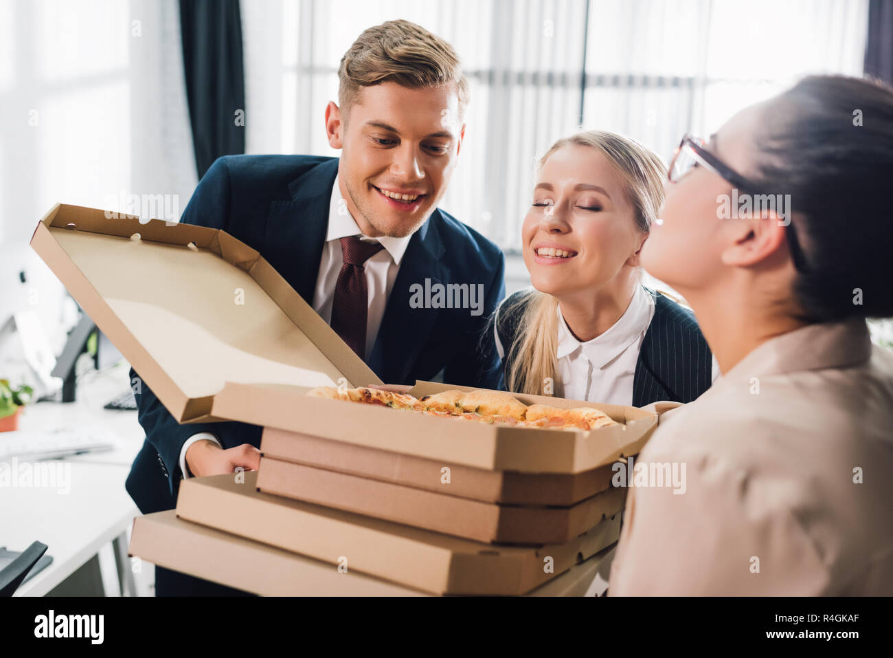 Smiling young female smelling pizza hi-res stock photography and images ...