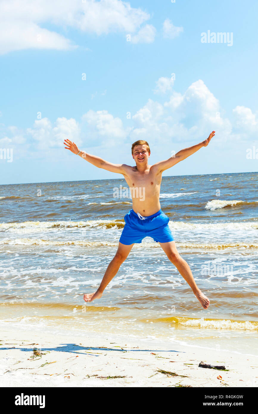 boy jumps in the air at the beach Stock Photo - Alamy