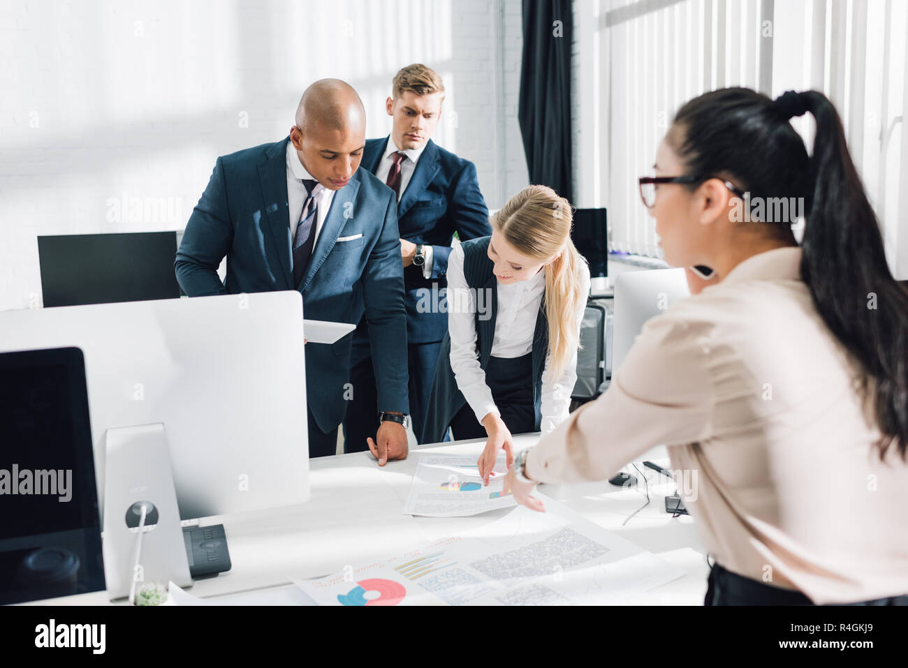 young multiracial business people working with charts and graphs in ...
