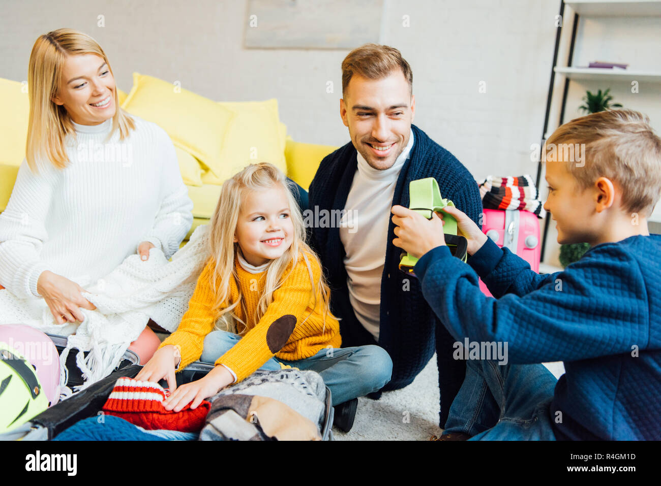 happy family having great time and packing for winter holidays Stock ...