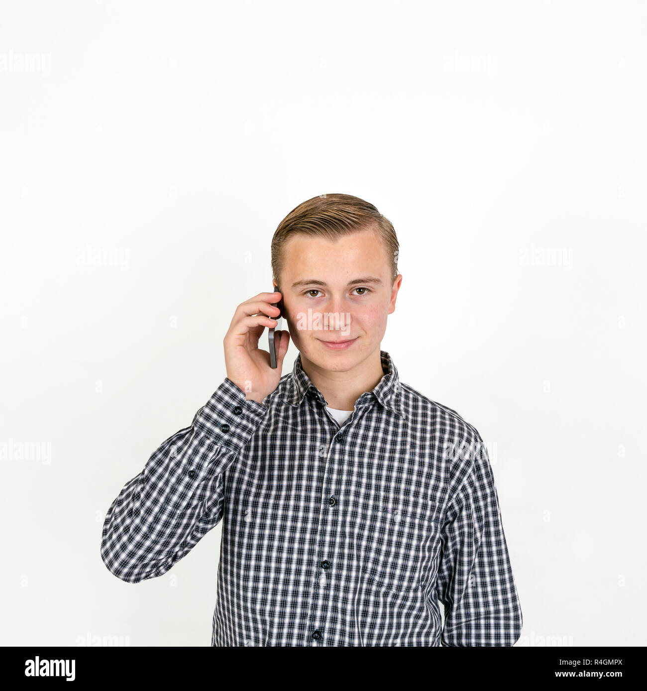 Handsome boy standing holding phone hi-res stock photography and images ...