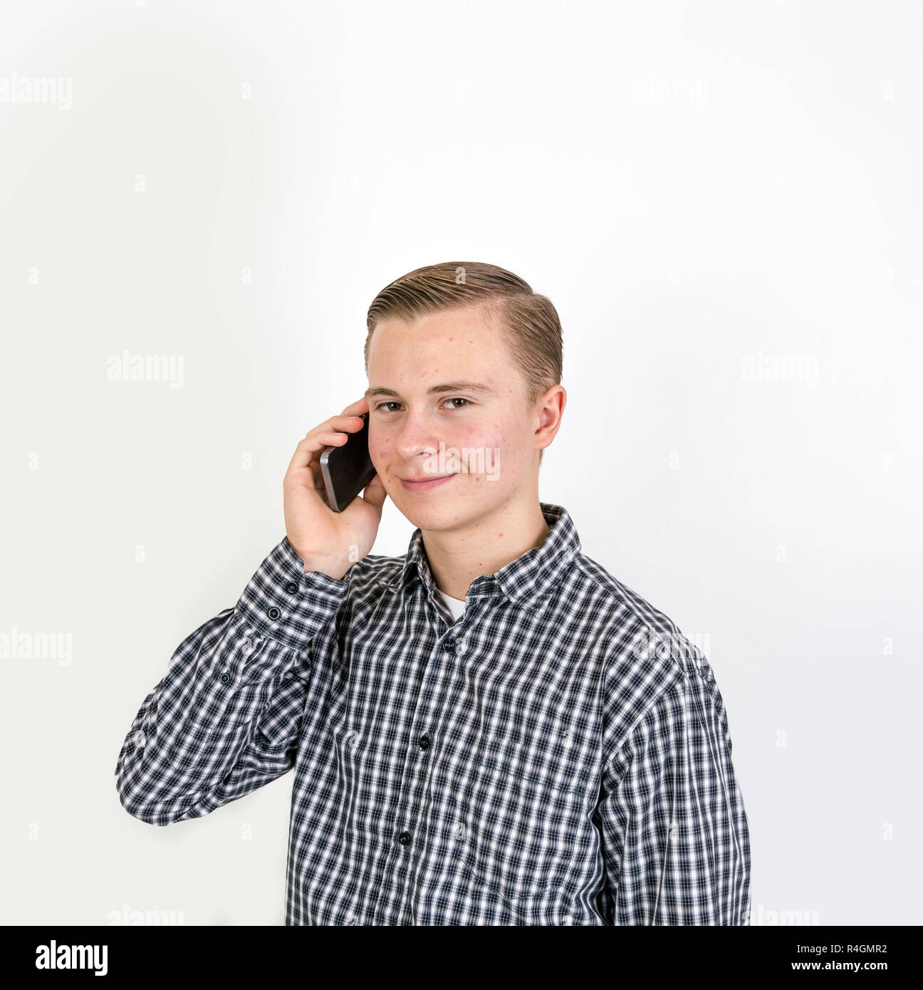 Handsome boy standing holding phone hi-res stock photography and images ...