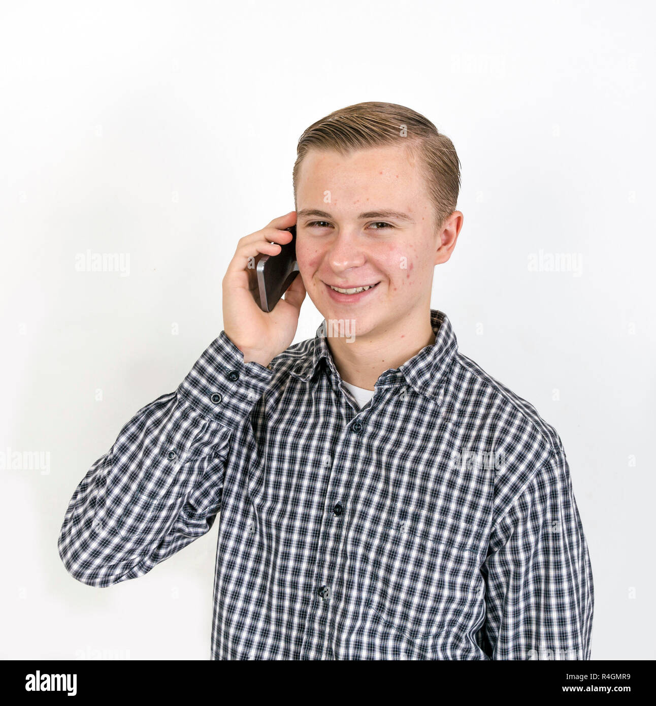 Handsome boy standing holding phone hi-res stock photography and images ...