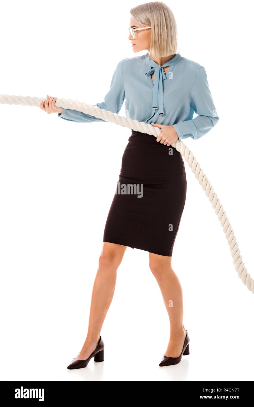 Concentrated beautiful businesswoman pulling rope isolated on white ...