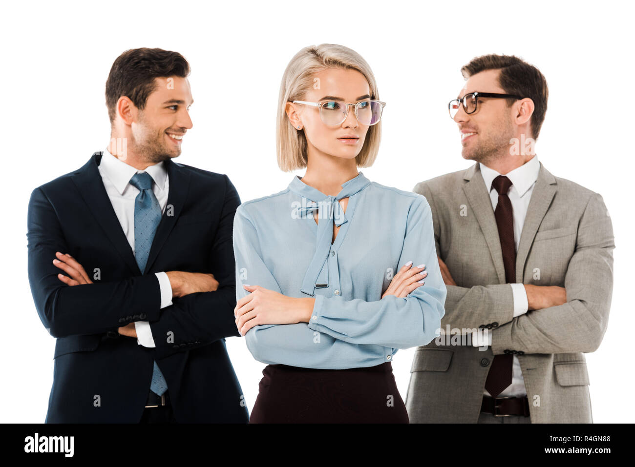 cheerful businessmen standing with arms crossed behind serious ...