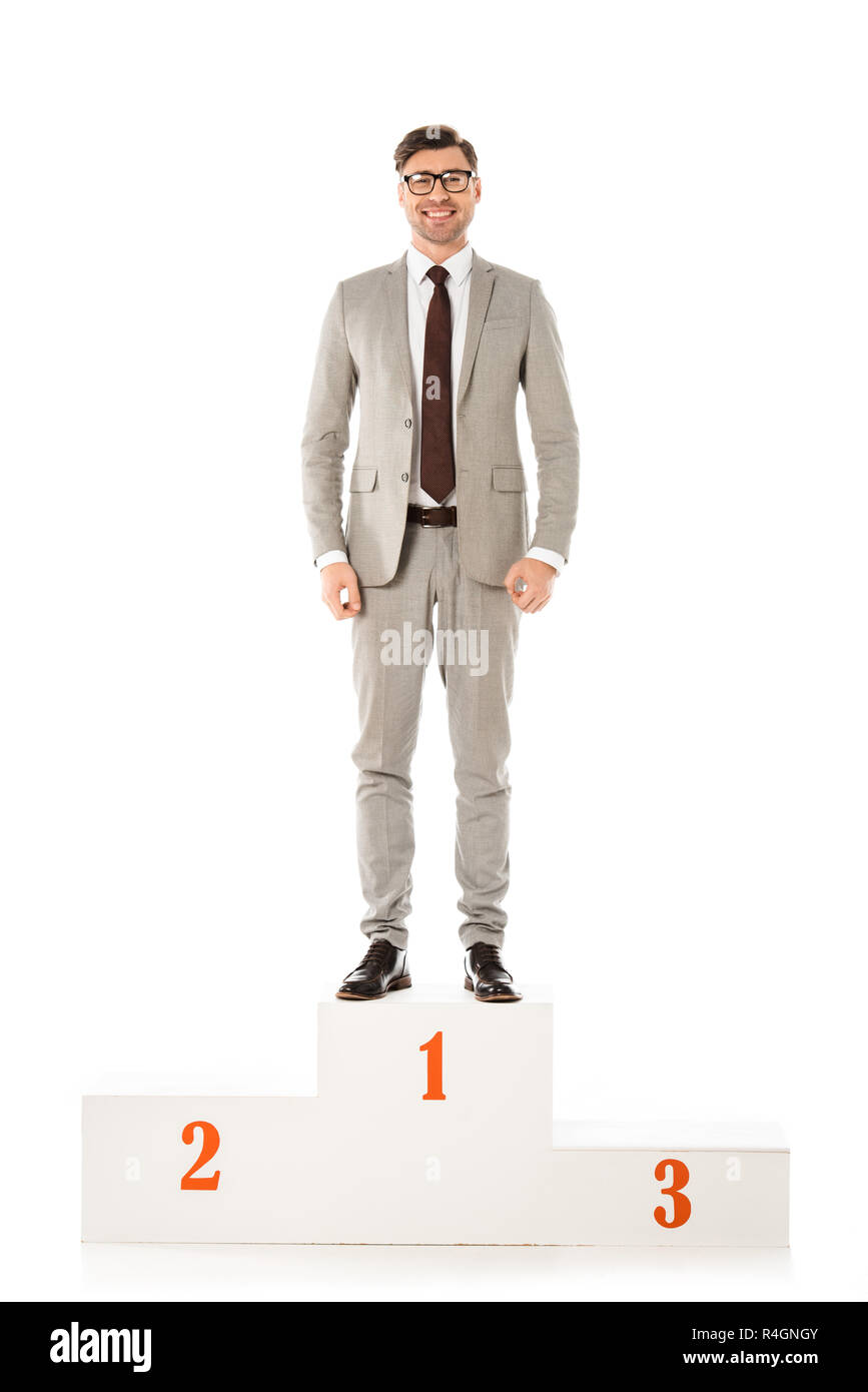 successful businessman standing on winners podium isolated on white ...