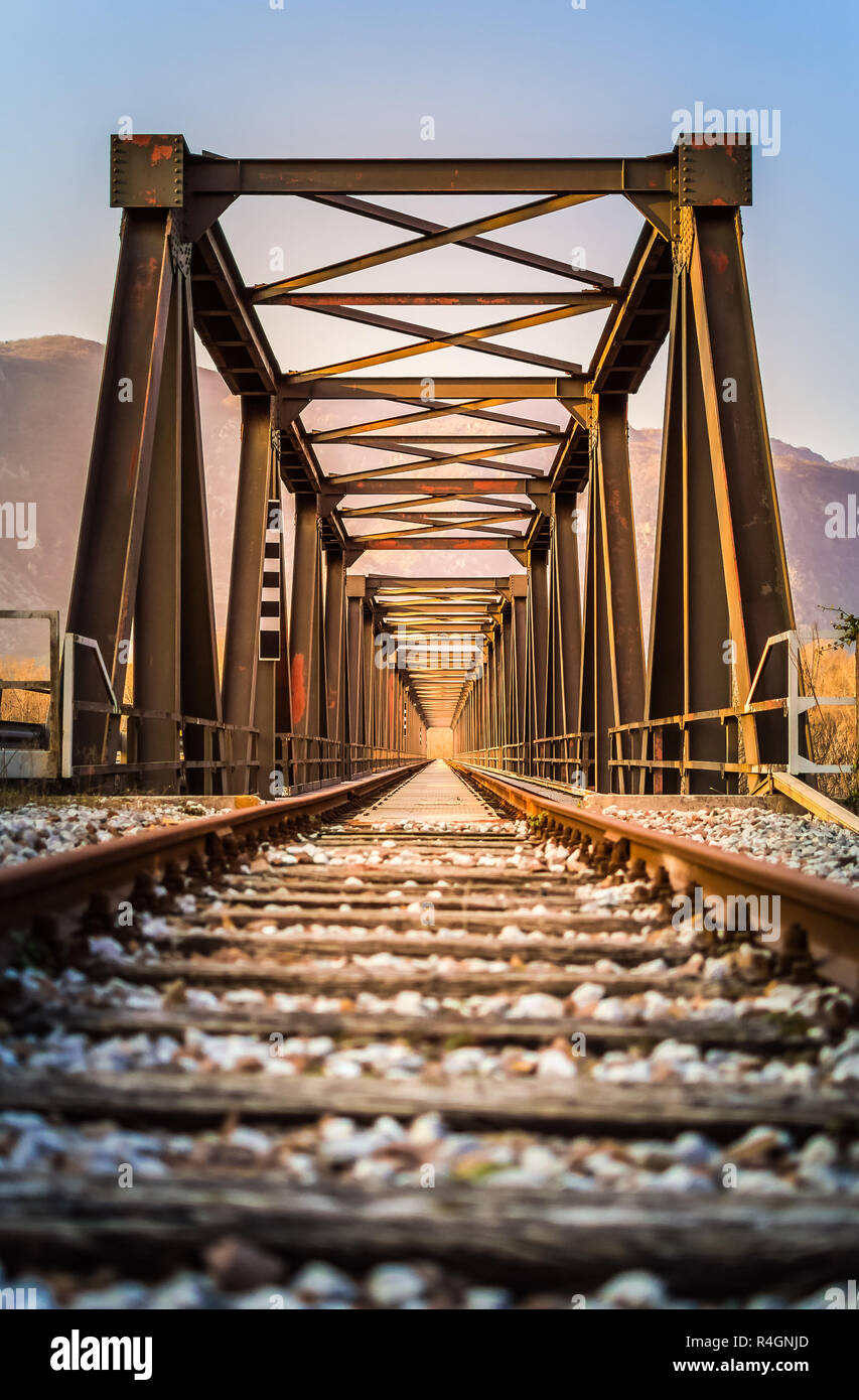 Old metal rail road bridge. With symmetrical metal structure and track ...