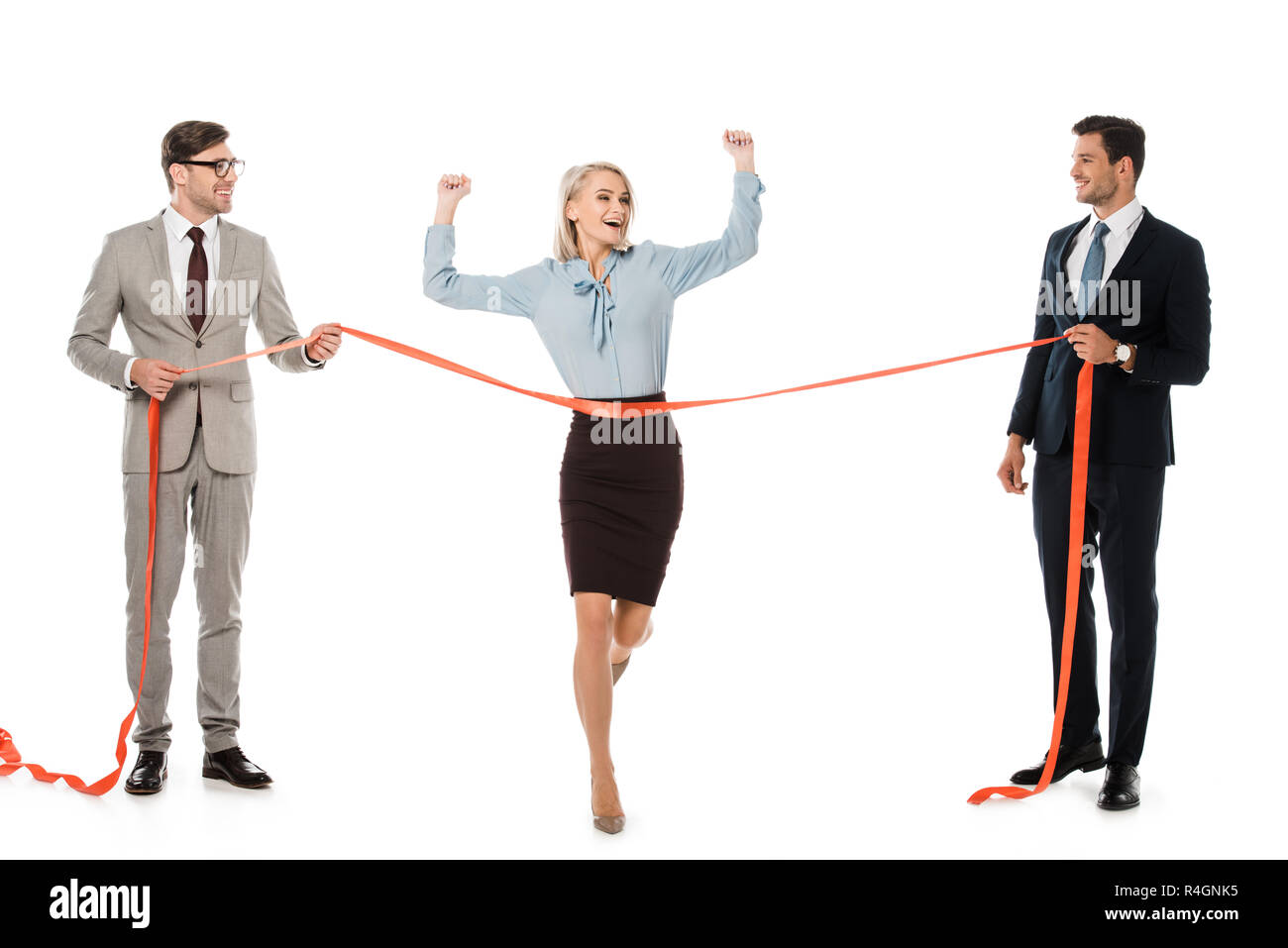 excited businesswoman reaching finishing line while businessmen holding ...