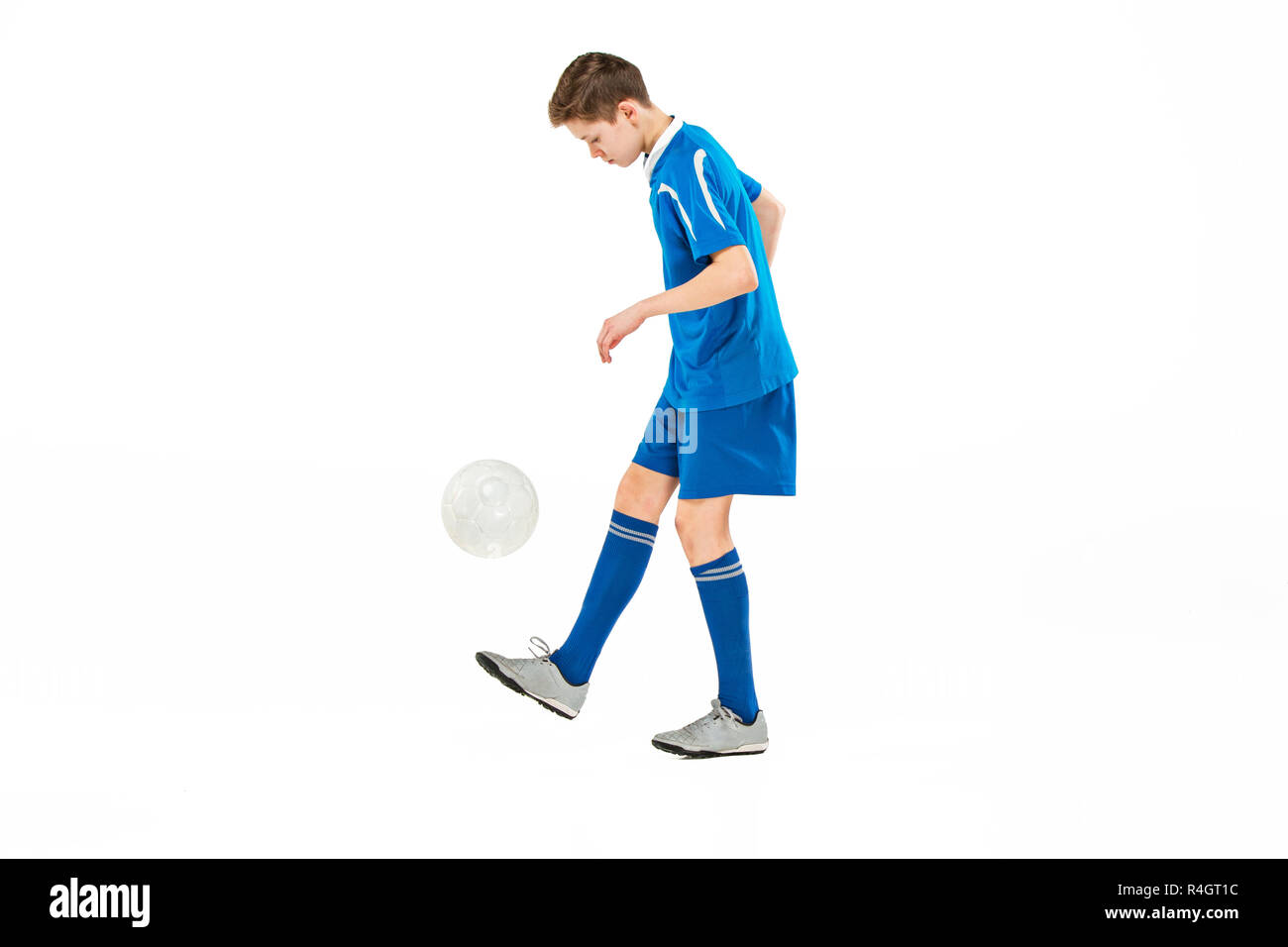 Young boy with soccer ball doing flying kick Stock Photo - Alamy