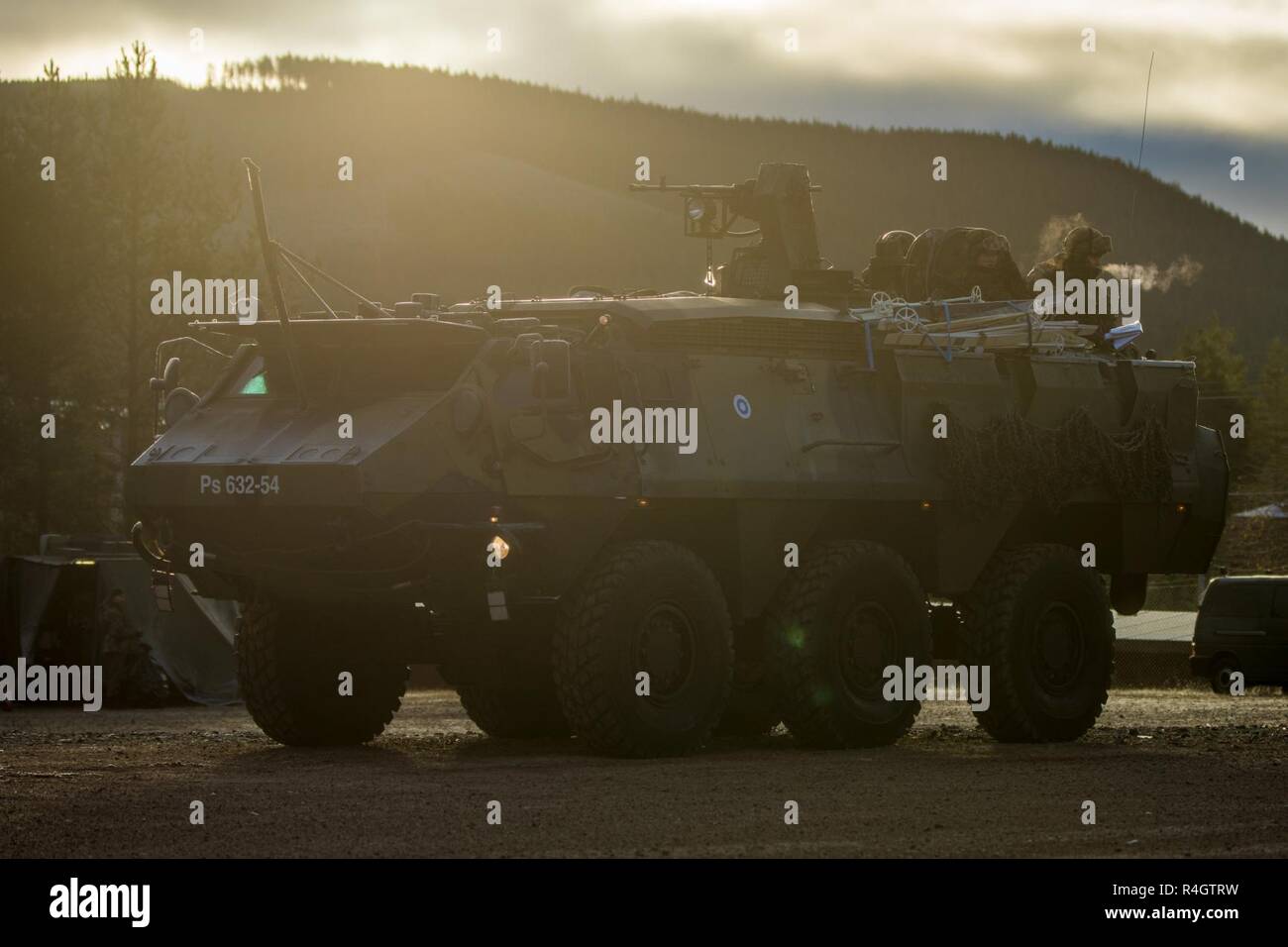 Dawn is breaking as the XA-203 armoured personnel carriers of the ...
