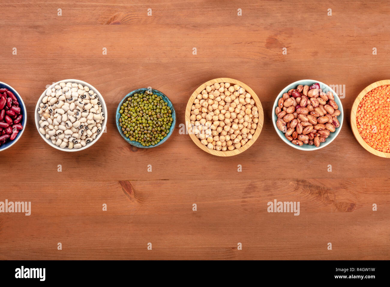 Types of legumes, shot from above on a dark rustic wooden background ...