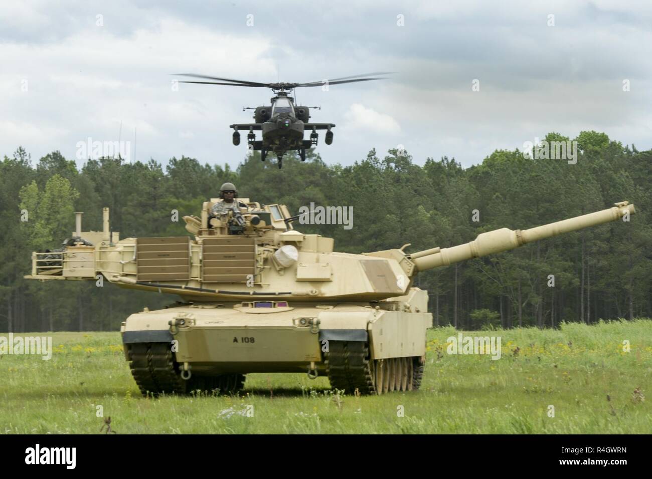 A U.S. Army M1 Abrams Main Battle Tank and a AH-64 Attack helicopter ...