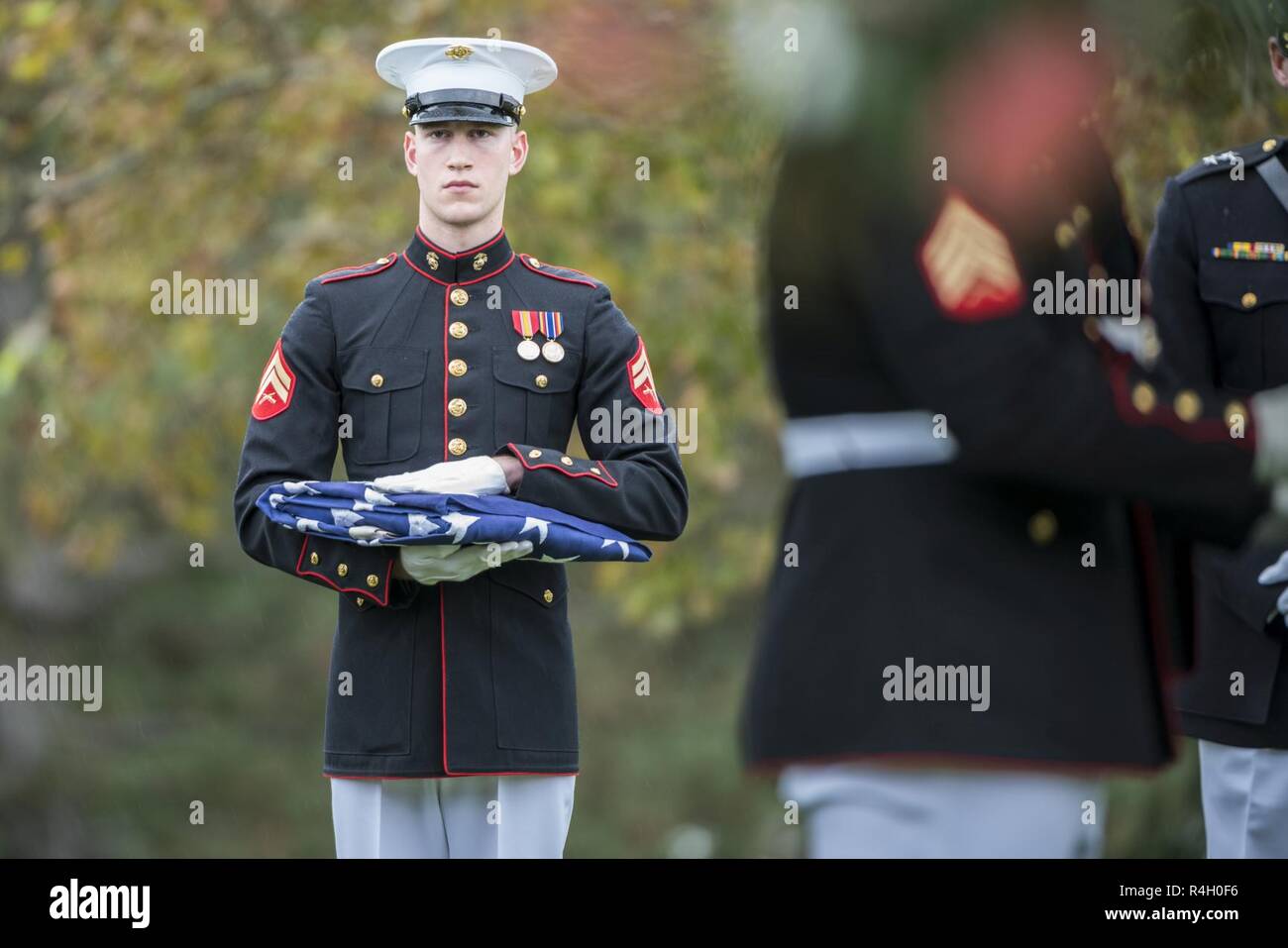 A Marine from the Marine Barracks, Washington, D.C. (8th and I) holds a ...