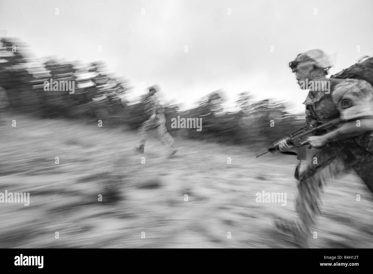 A New Jersey Army National Guard combat medic runs to simulated ...