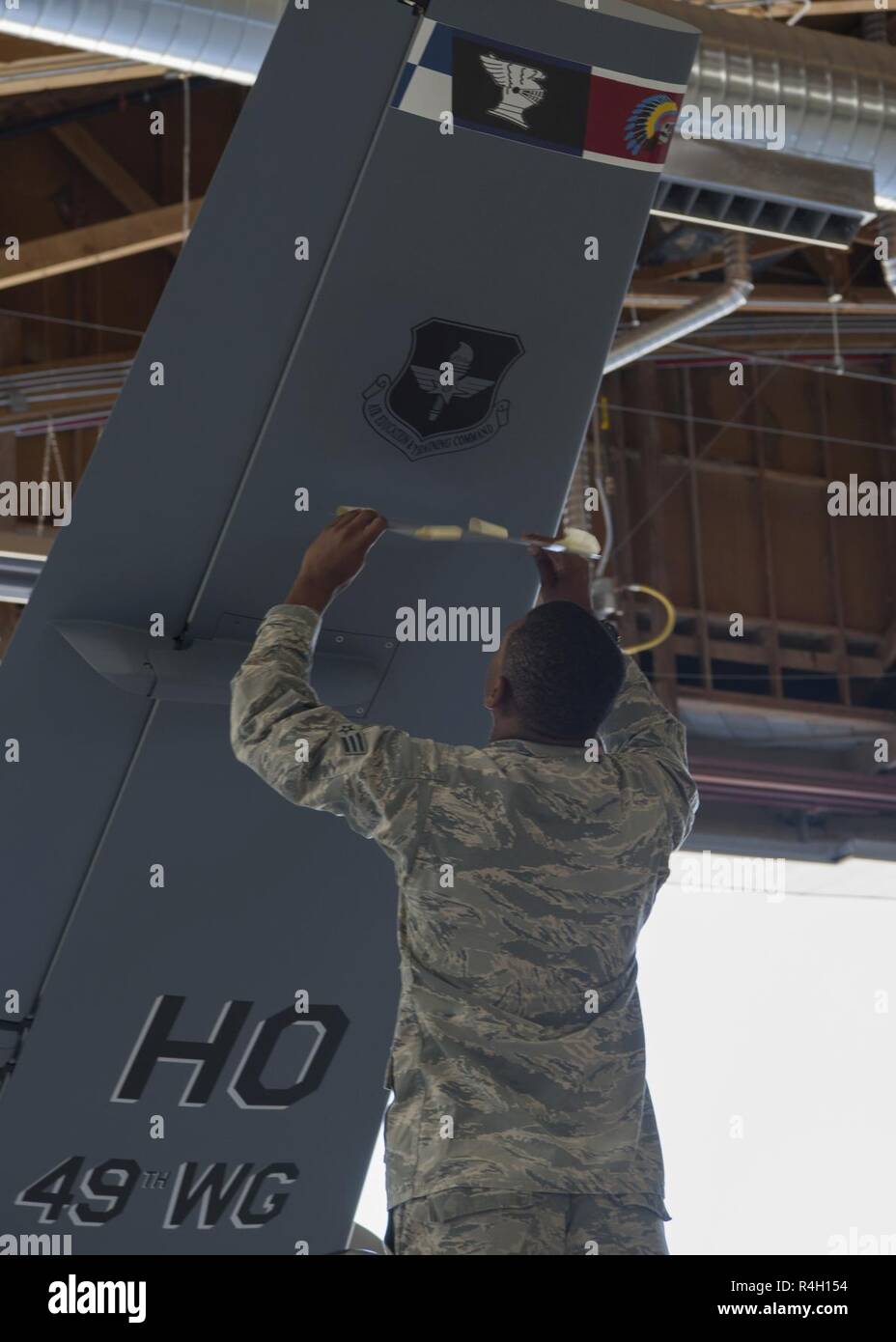 Senior Airman Kawan Dickerson, 49th Aircraft Maintenance squadron maintainer, peels back the ...