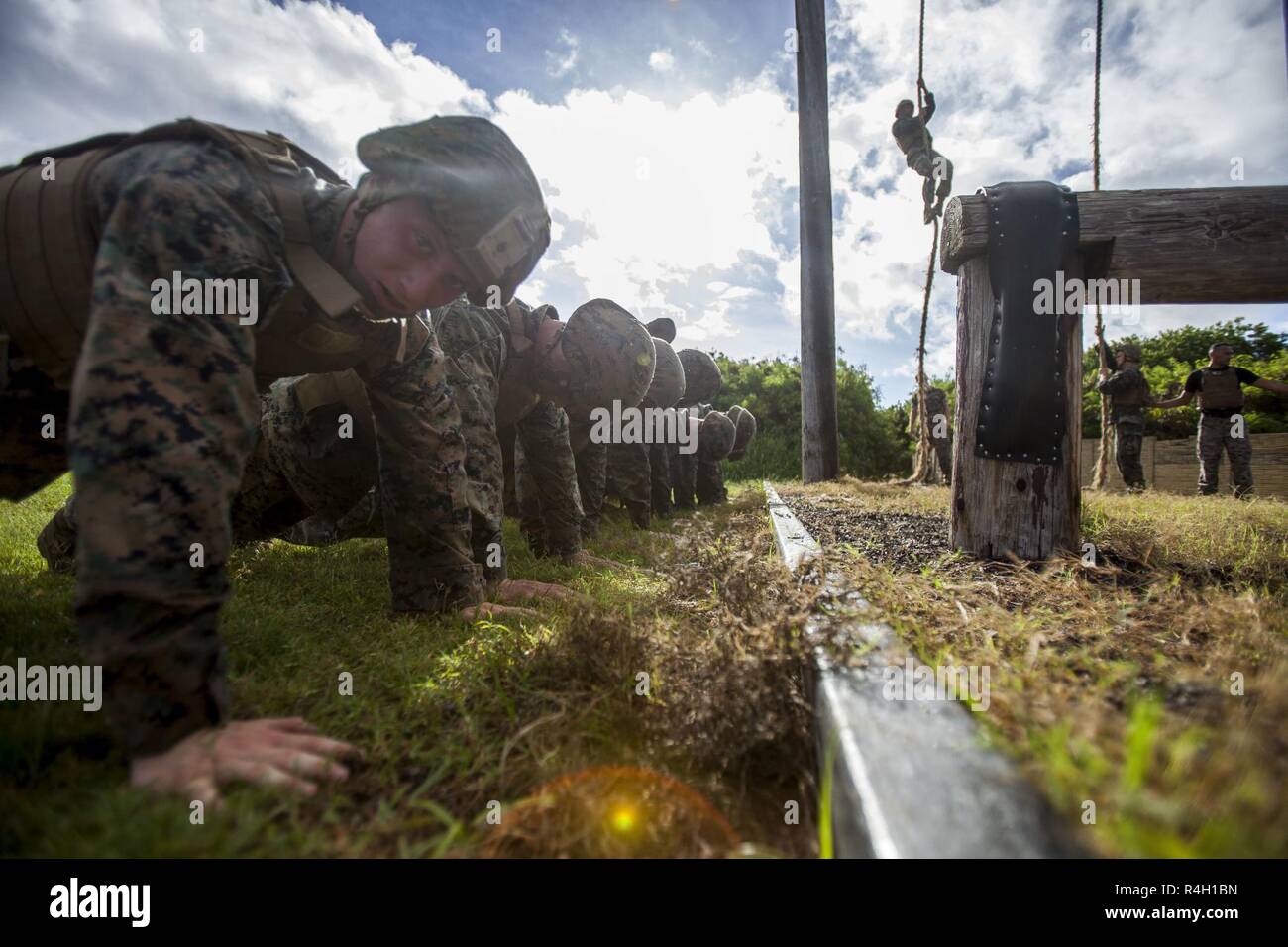 U.S. Marines conduct planks in part of an obstacle course during a ...