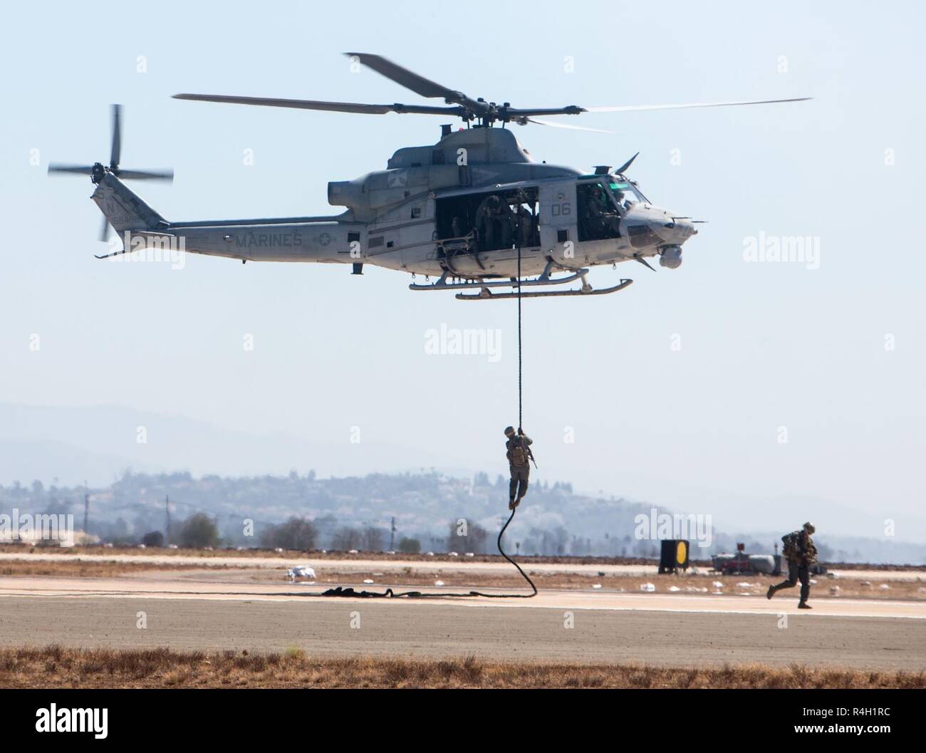U.S. Marines with 1st Marine Division repel from a UH-1Y Huey during ...
