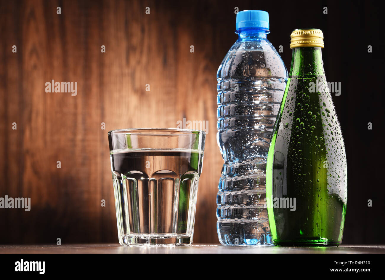 Composition with glass and bottles of mineral water Stock Photo - Alamy