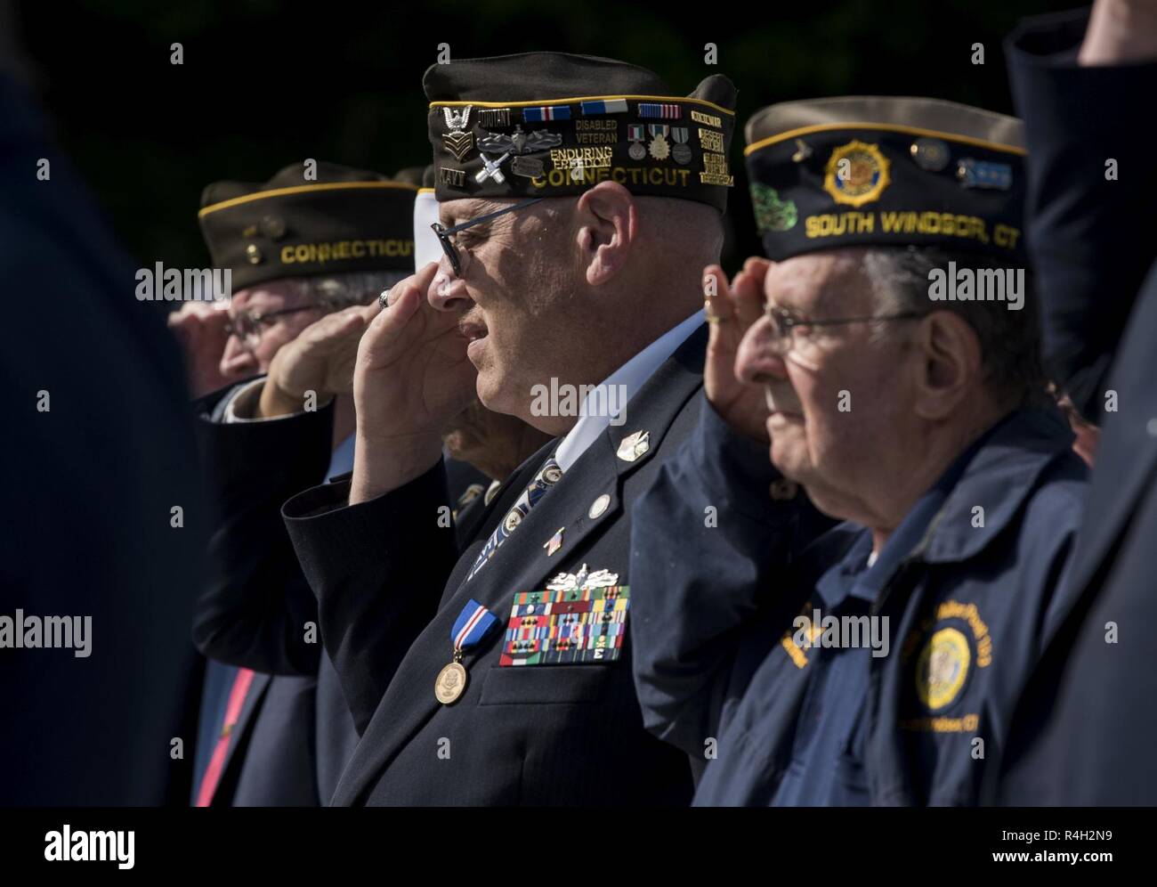Attendees salute during a memorial dedication and Medal of Honor ...