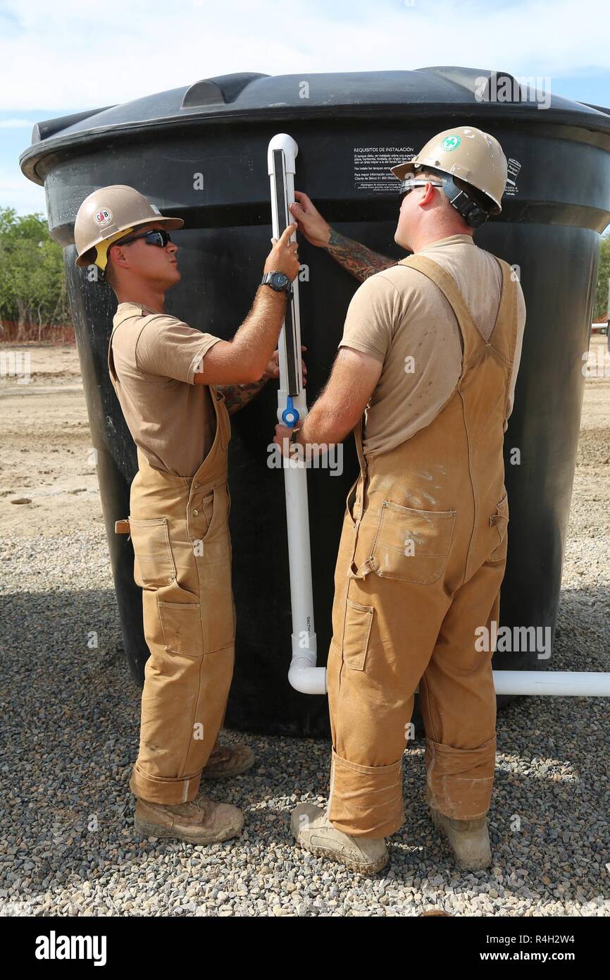 U.S. Navy Utilitiesman 2nd Class Anthony Calleja (left) and ...
