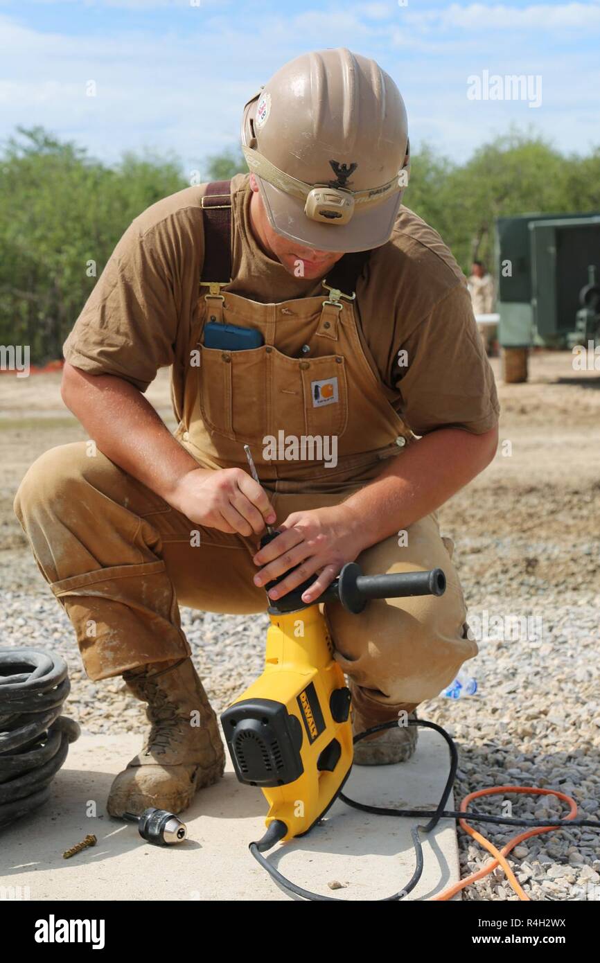 U.S. Navy Builder 3rd Class Zachary Paiva, assigned to Naval Mobile ...