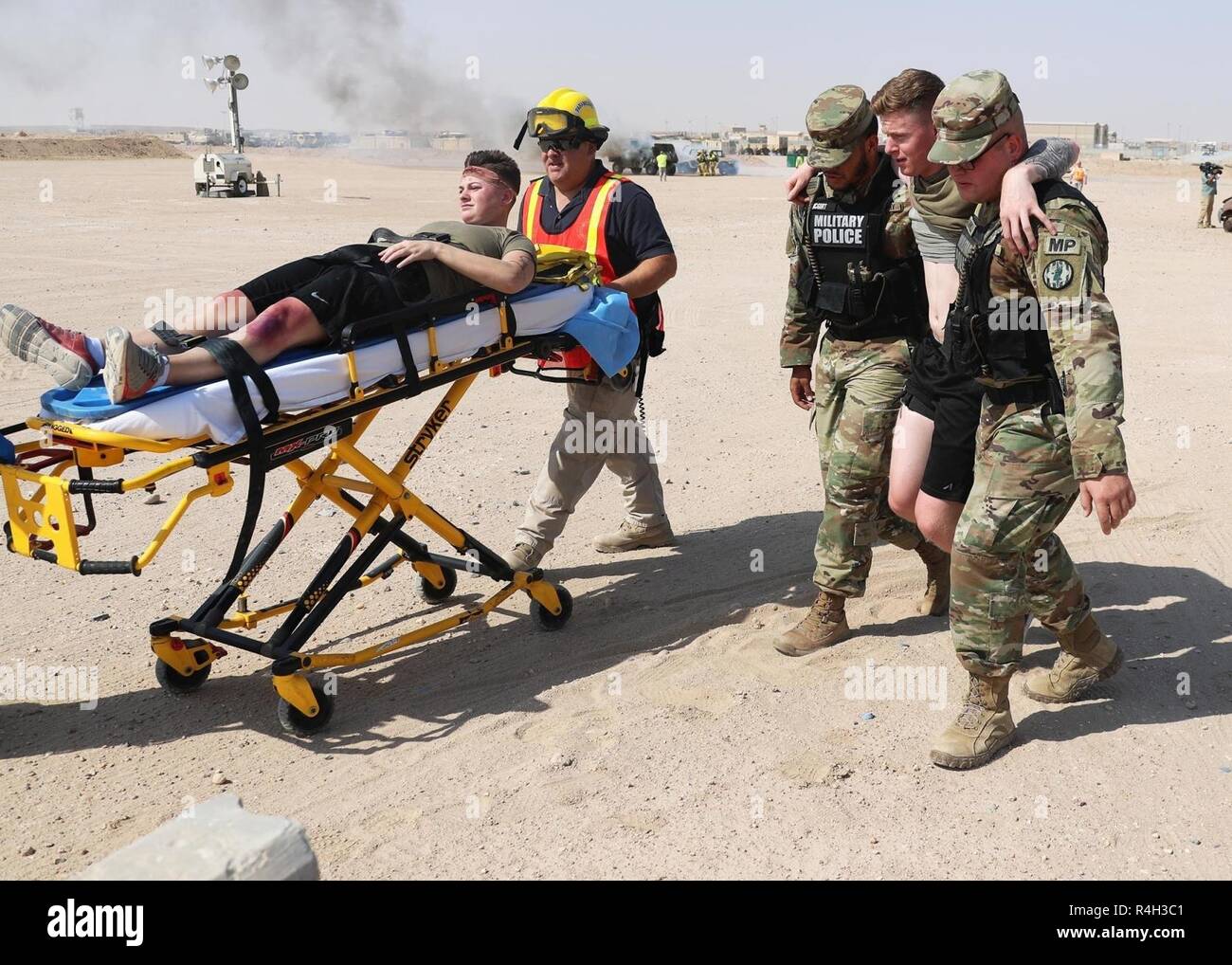 Military police and the Camp Buehring EMS personnel assist injured ...