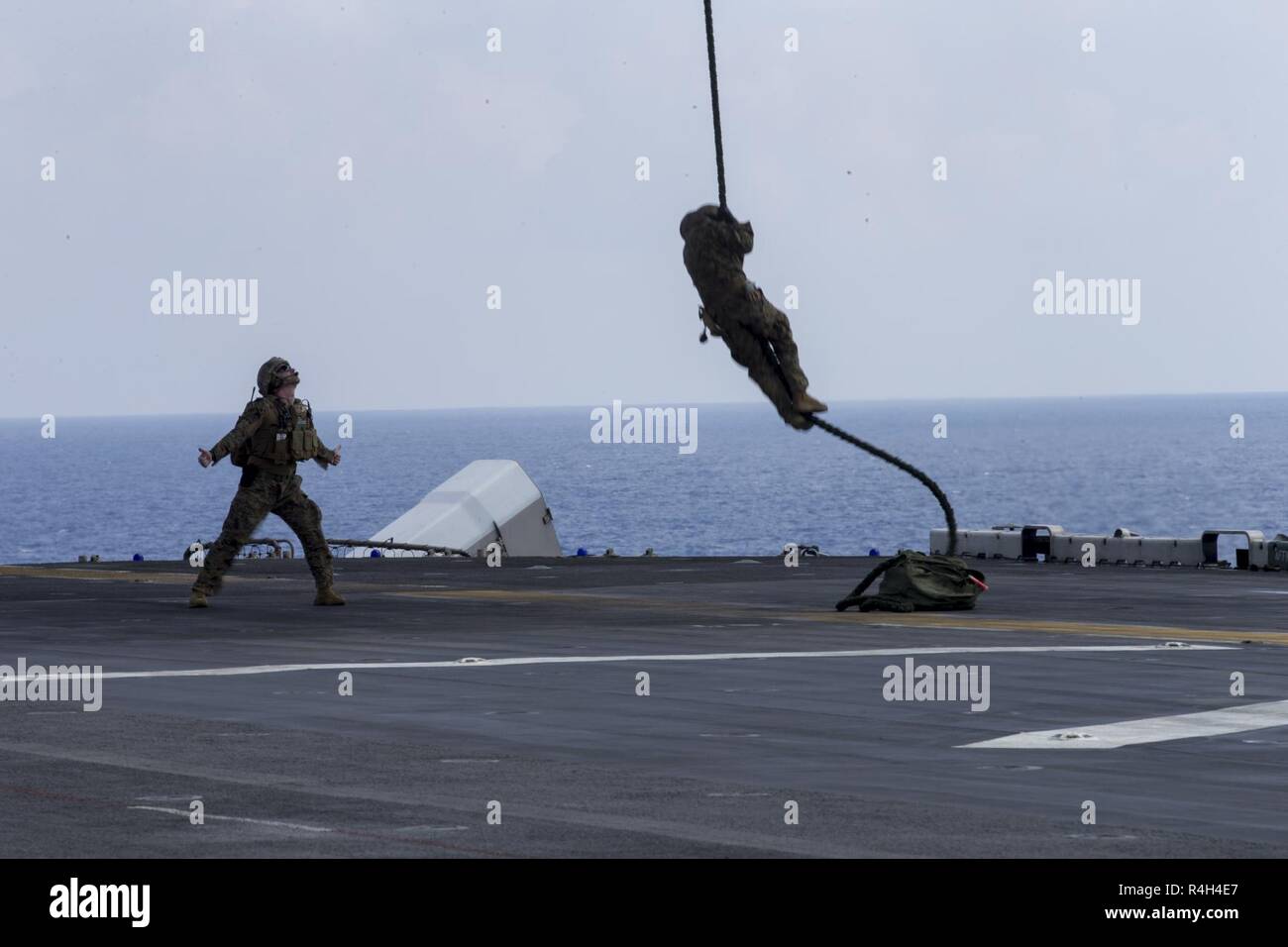 A Marine with the 31st Marine Expeditionary Unit fast-ropes from a CH ...