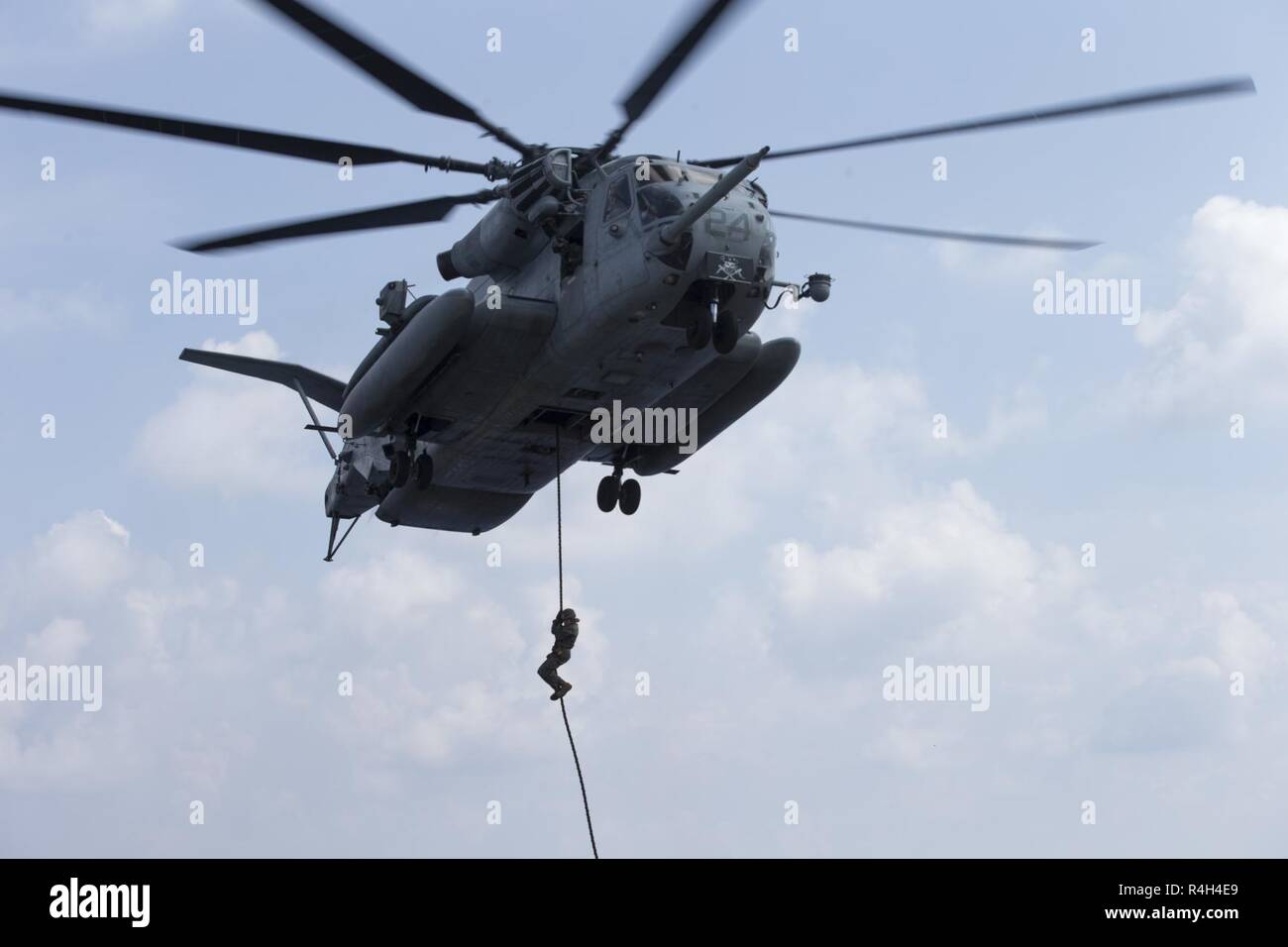 A Marine with the 31st Marine Expeditionary Unit fast-ropes from a CH ...
