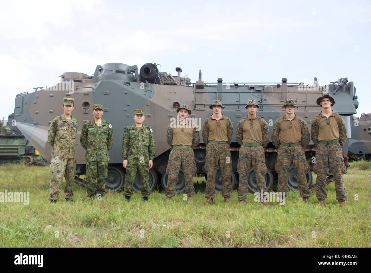 Amphibious Rapid Deployment Brigade soldiers and U.S. Marines take a group photo in front of ...