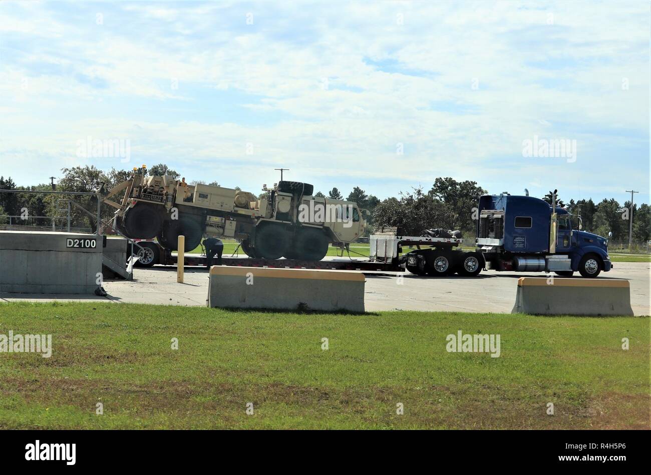 A military vehicle is loaded on a tractor-trailer Sept. 27, 2018, at ...