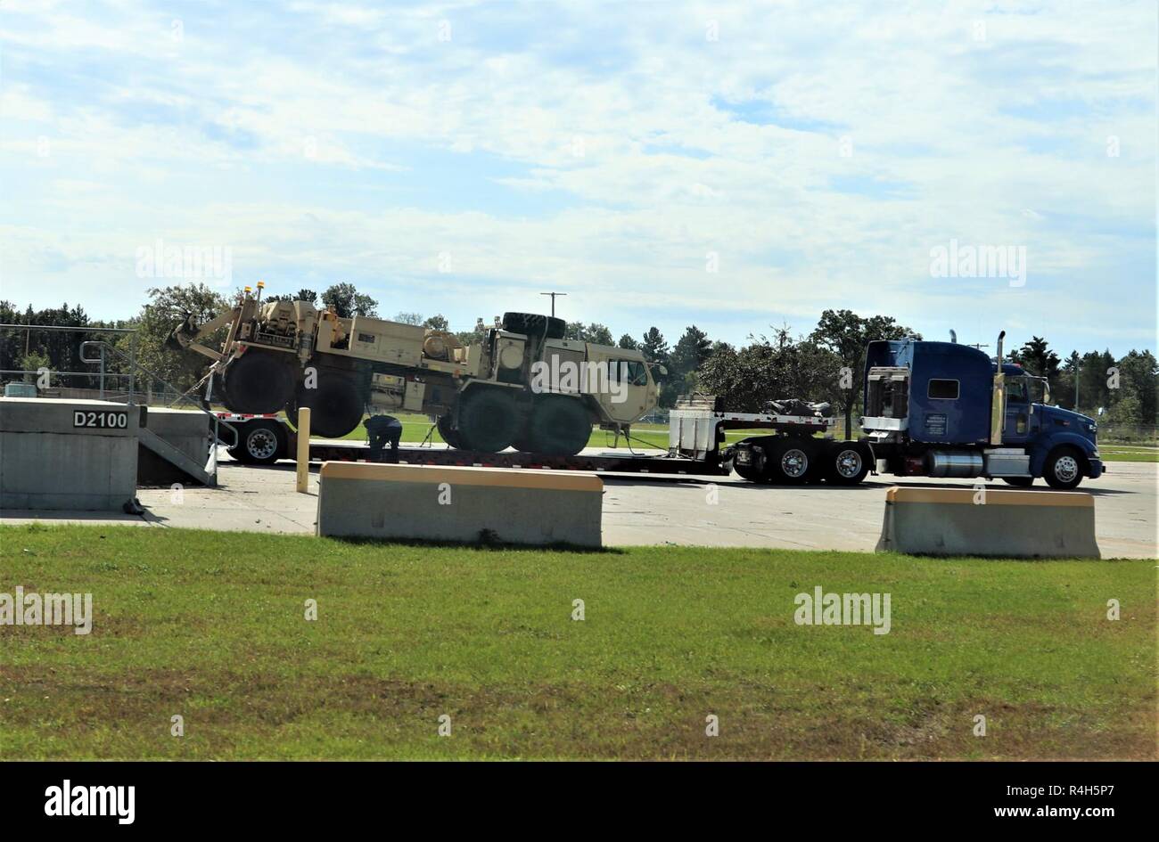 A military vehicle is loaded on a tractor-trailer Sept. 27, 2018, at ...