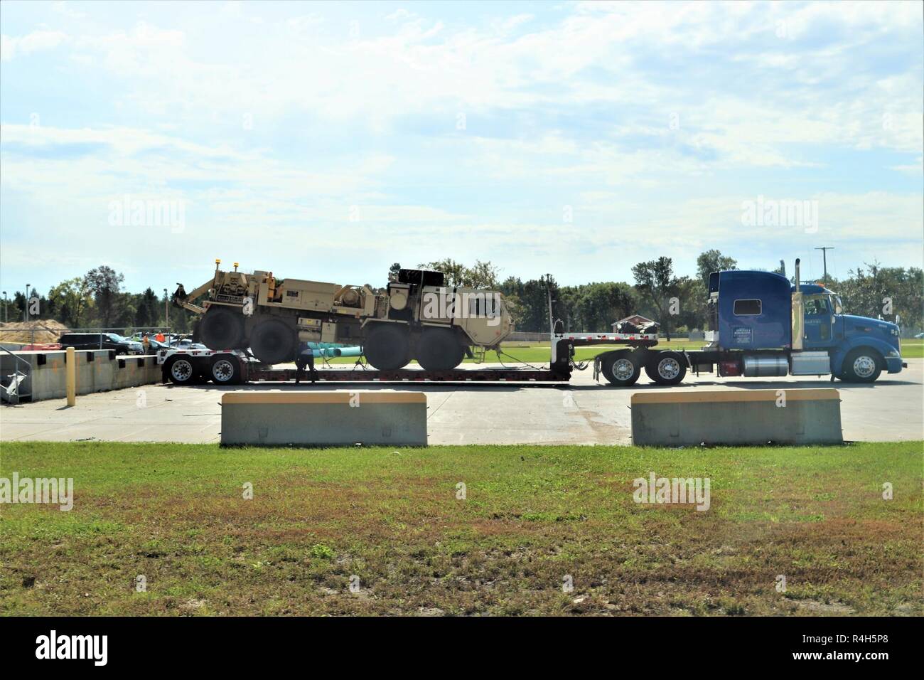 A military vehicle is loaded on a tractor-trailer Sept. 27, 2018, at ...