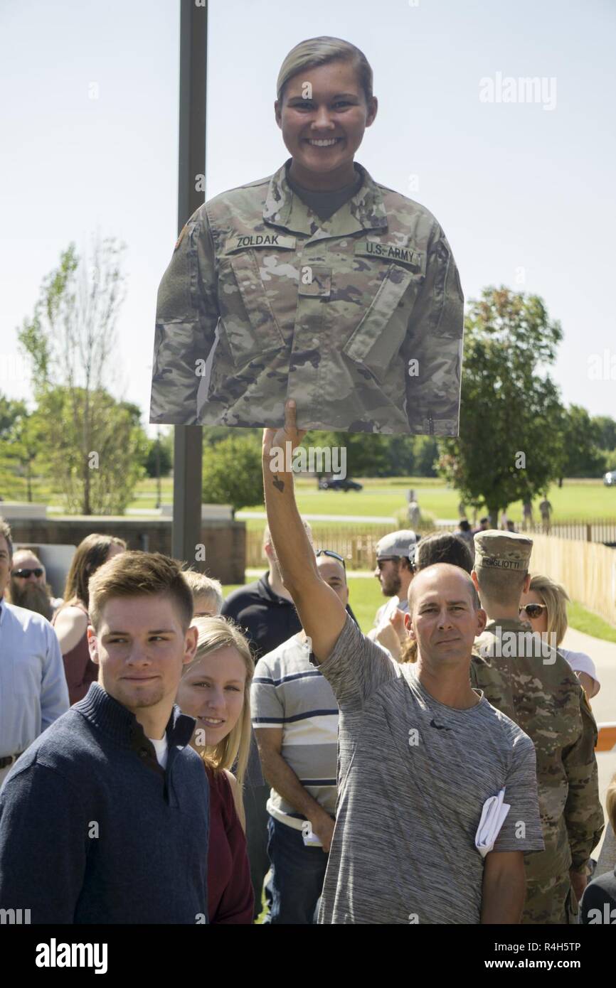Family members of Pfc. Madeline Zoldak (on the cutout sign) prepare to ...