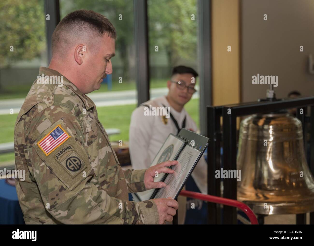 Army Staff Sergeant Neal reads a list of the names of fallen service ...