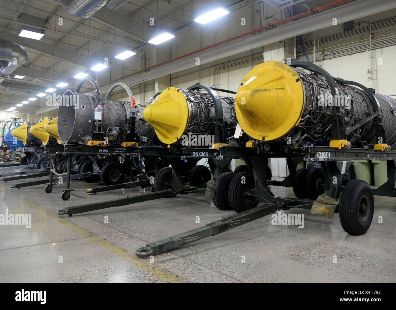 Spare F-16 Fighting Falcon engines sit on engine trailers inside the ...