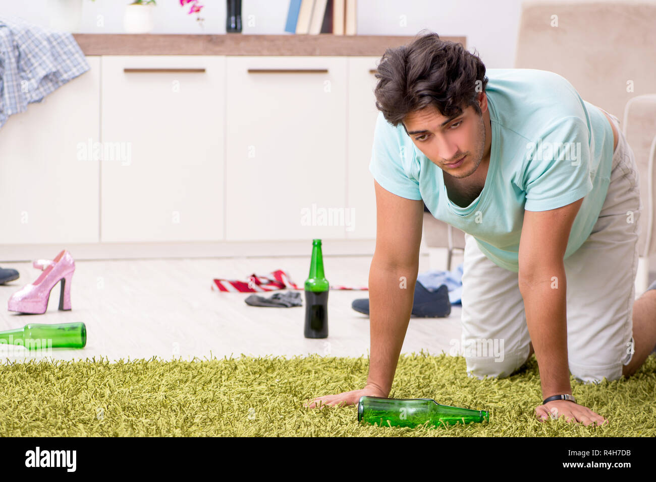 Young drunk handsome man after party at home Stock Photo - Alamy