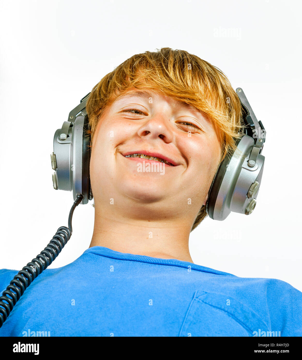 cute handsome boy listening to music by headphones Stock Photo - Alamy