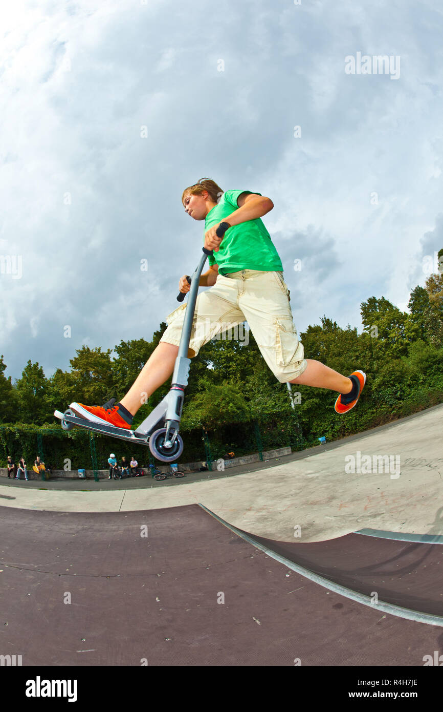 boy jumping in the air with his scooter Stock Photo - Alamy