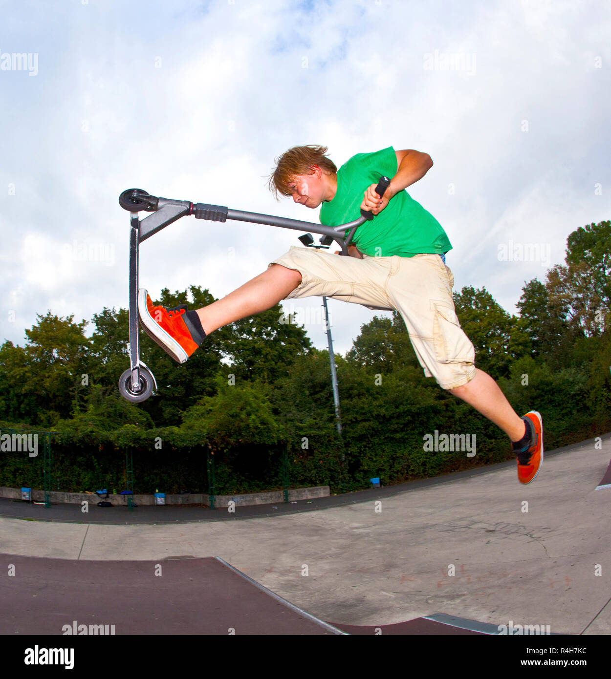 boy jumping in the air with his scooter Stock Photo - Alamy
